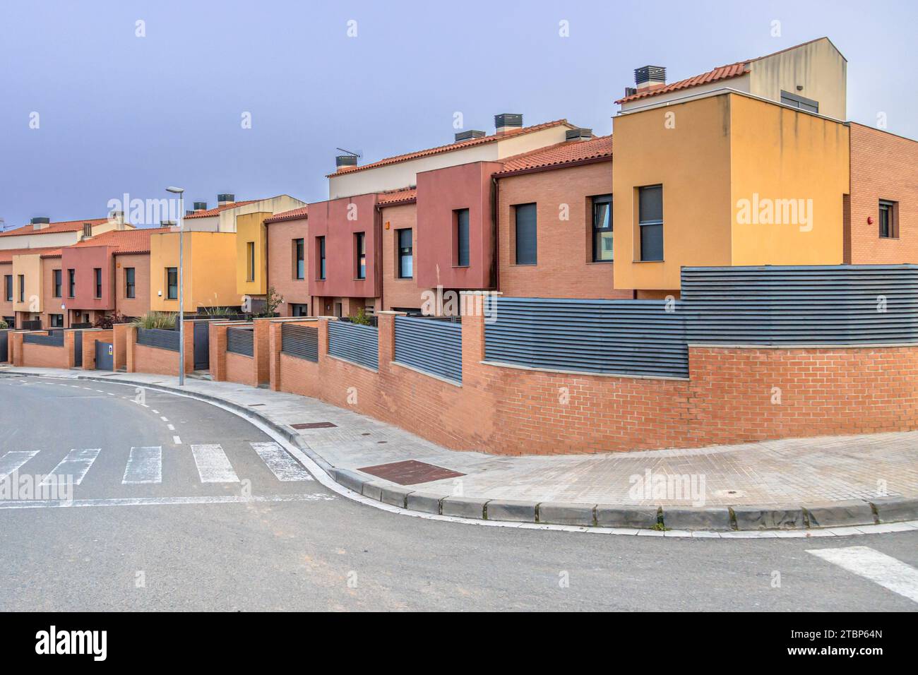 Modern row houses in Terra earth colors in Spain Stock Photo - Alamy