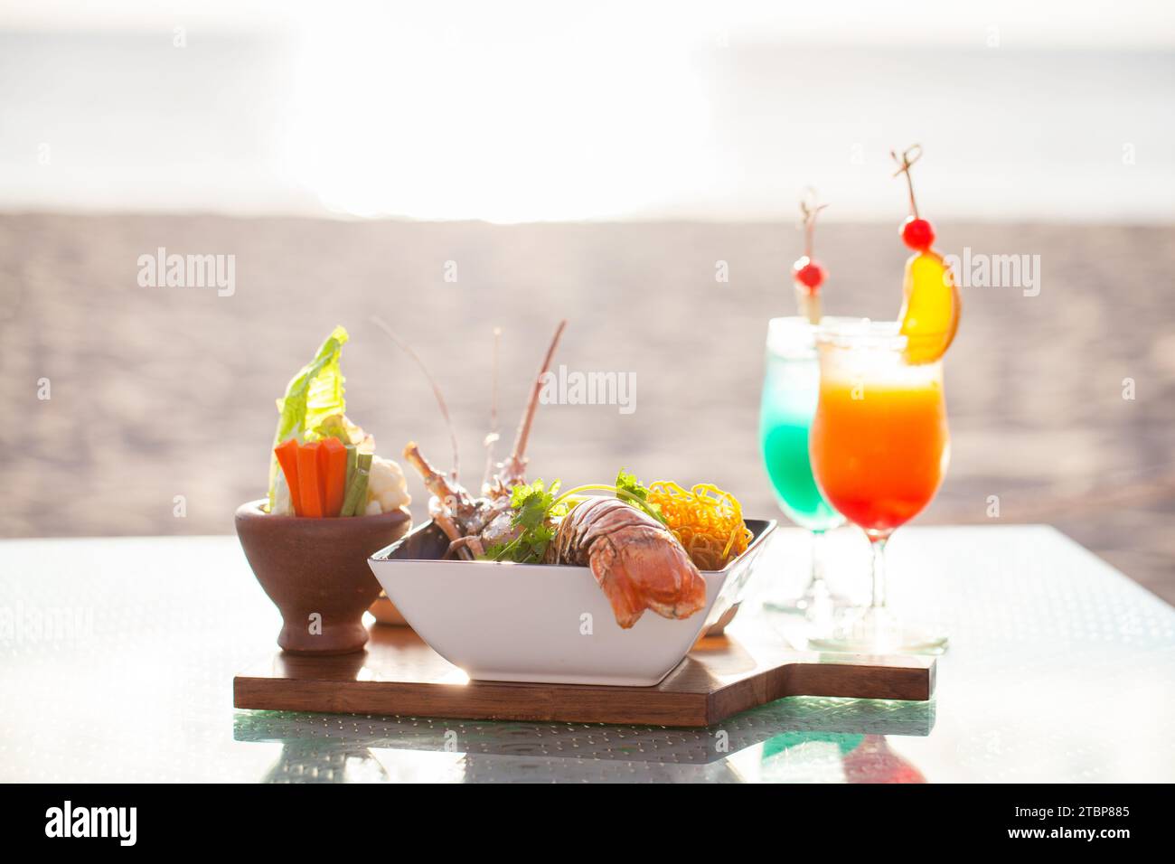 Beachfront dining experience with seafood platter and tropical cocktail ...
