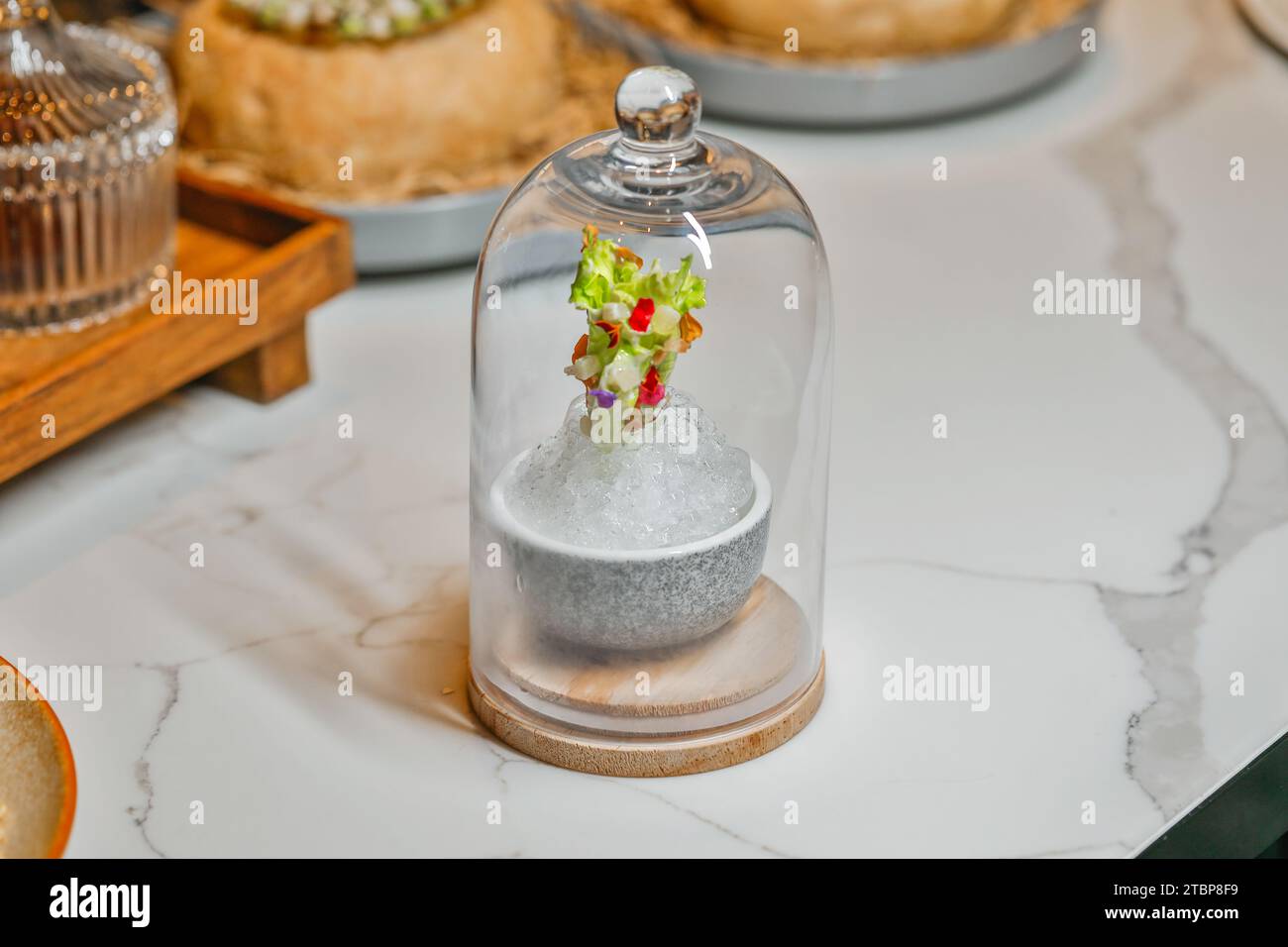 Plant growing under glass dome on marble table. Sustainable living and ...