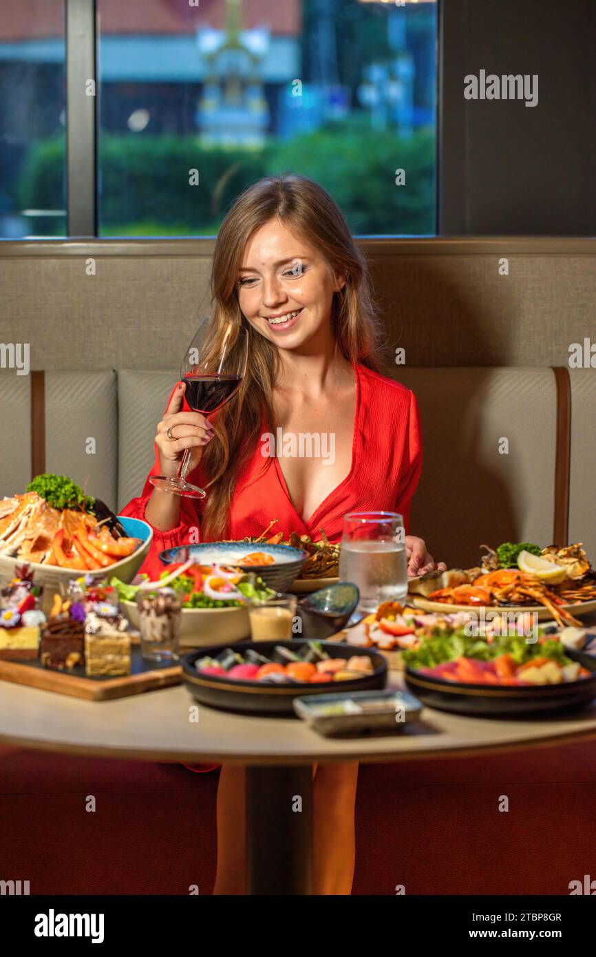 Elegant woman enjoying gourmet meal in refined restaurant. Dining and ...