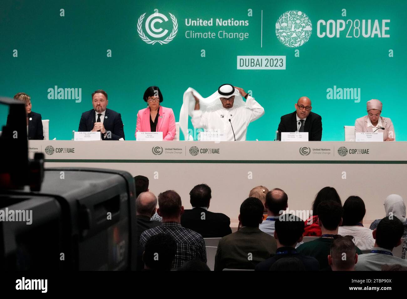 COP28 President Sultan al-Jaber, center, adjusts his ghutra during a ...