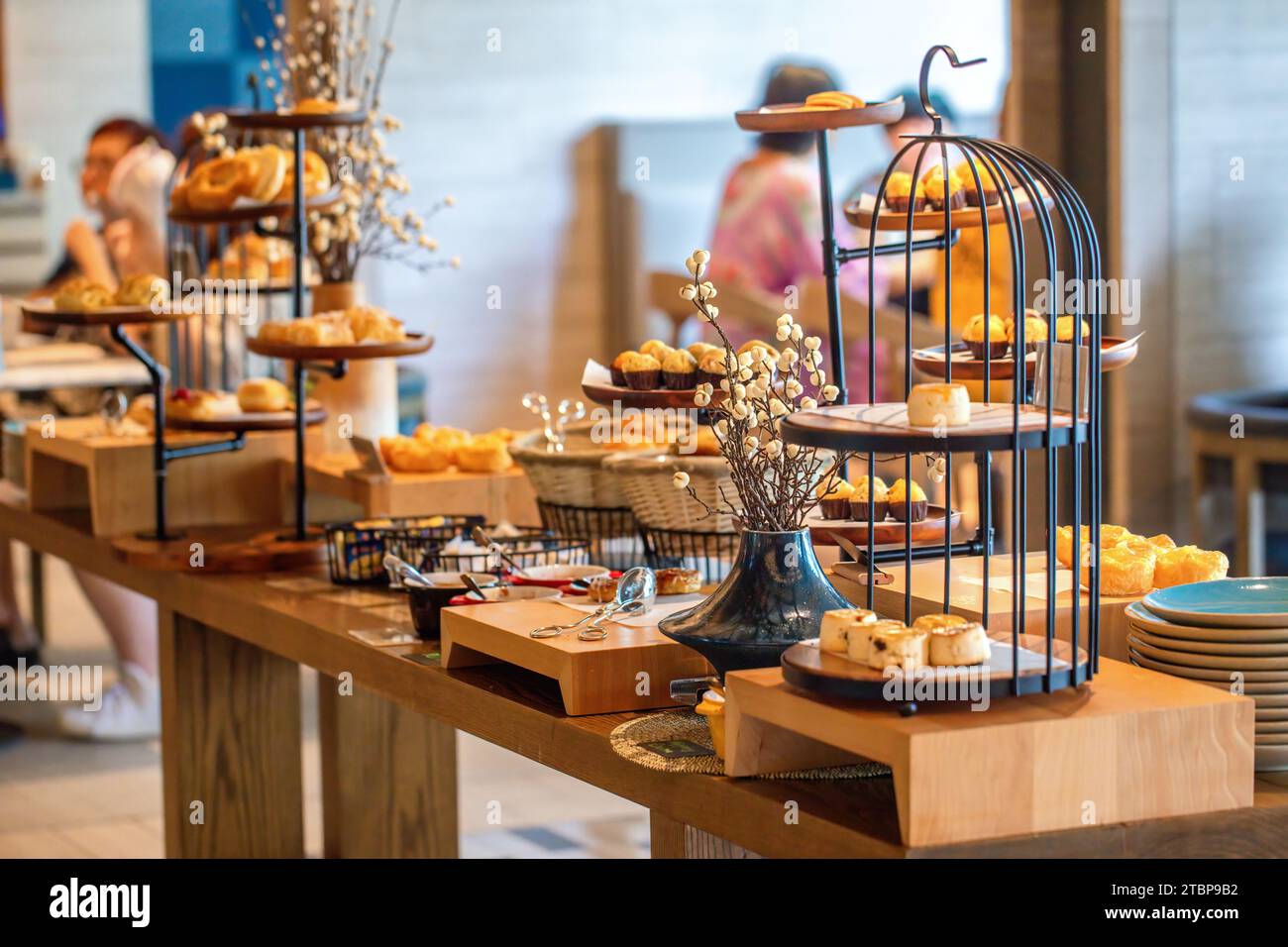 Assorted pastries on display in modern bakery shop. Gourmet and ...