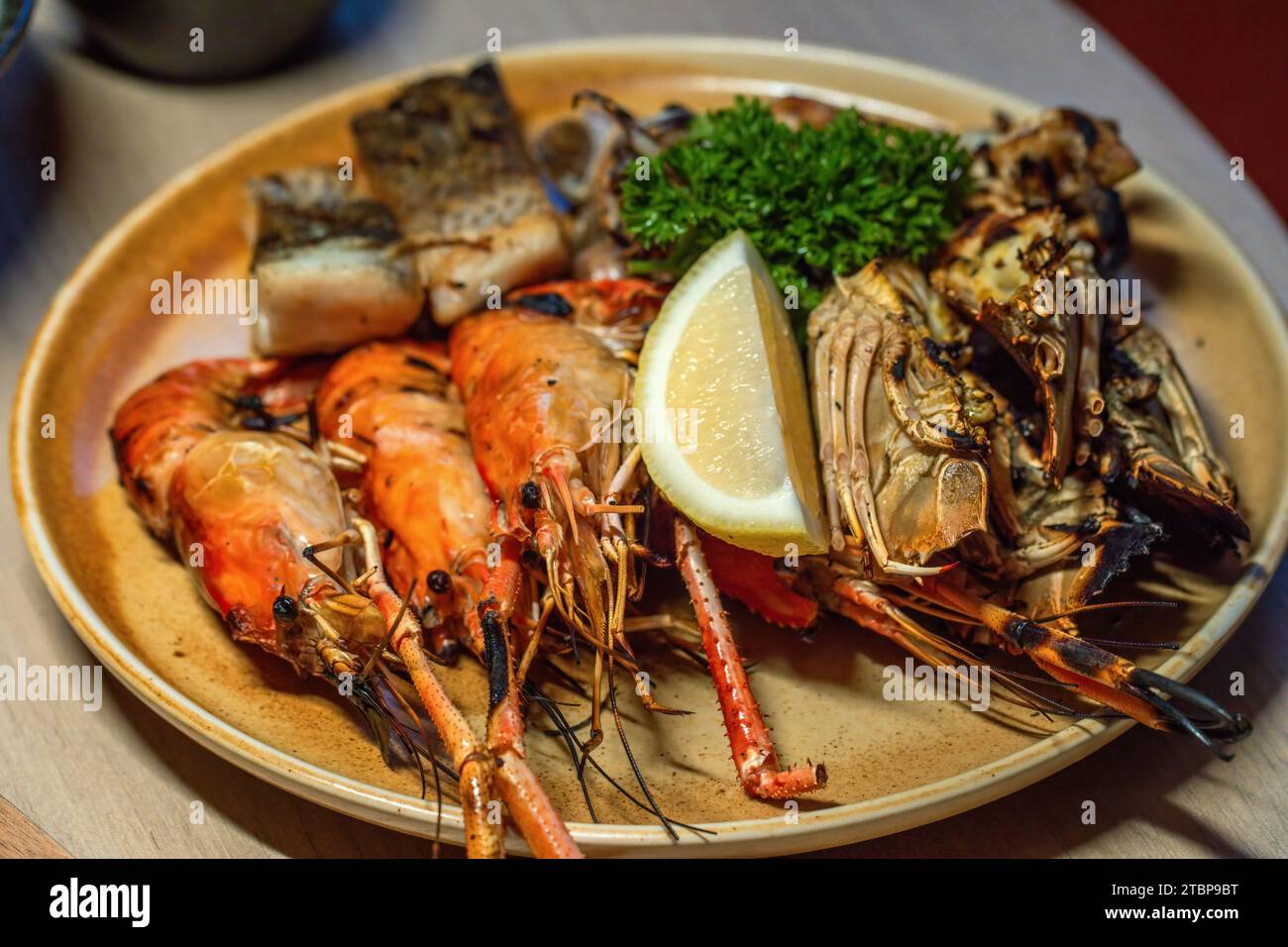 Seafood platter with shrimp, fish, and crab garnished with lemon ...