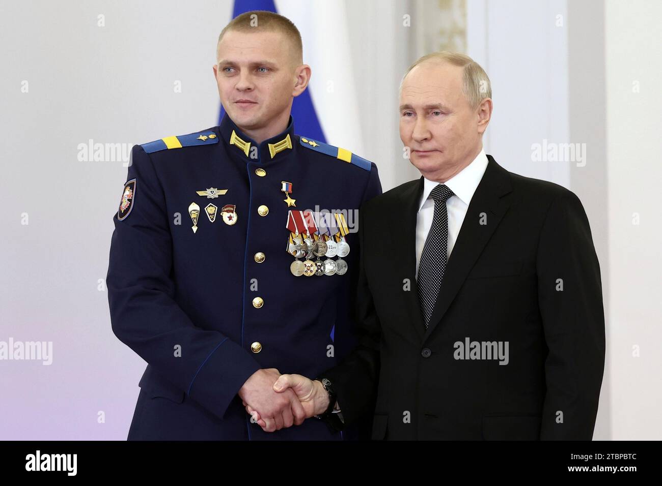 Russian President Vladimir Putin, right, poses for a photo with Sgt. Alexander Mikhailov during ...