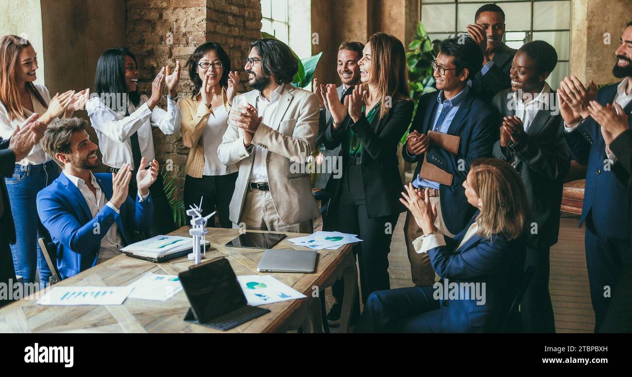 Multigenerational colleagues clapping hands for a succesful green ...