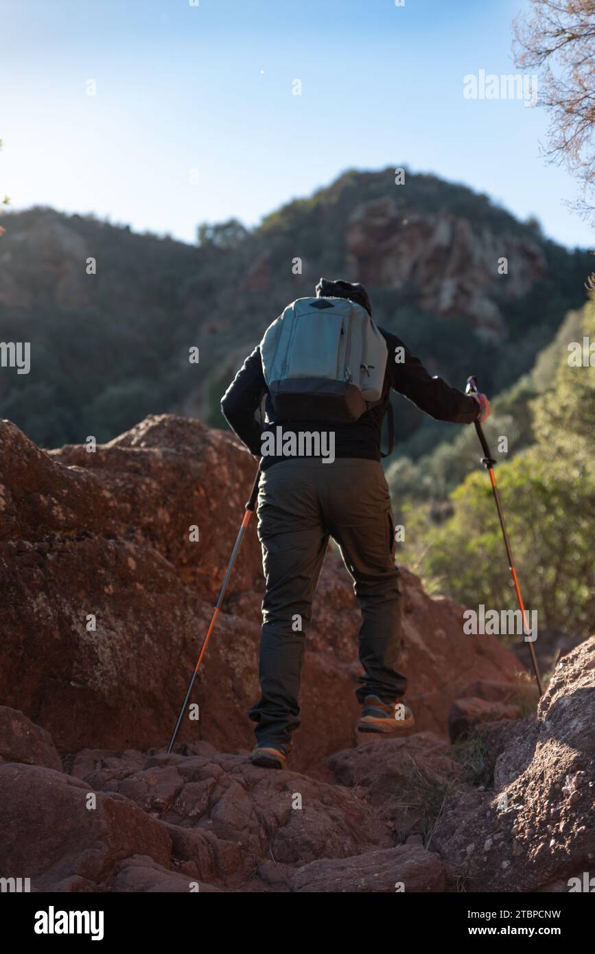 Middle-aged man climbs the mountain in the Garraf Natural Park ...