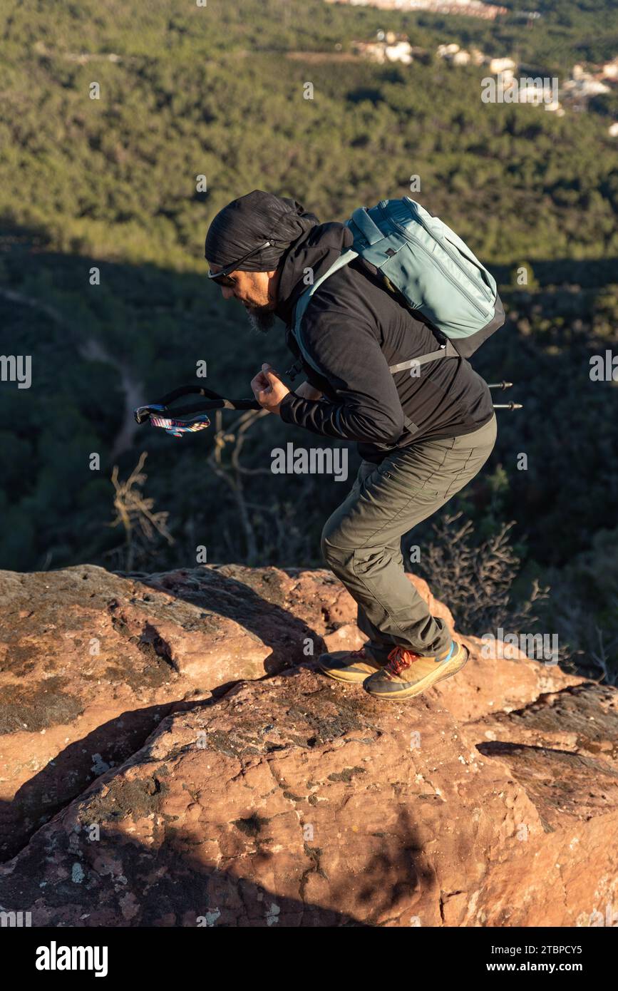 Middle-aged man climbs the mountain in the Garraf Natural Park ...