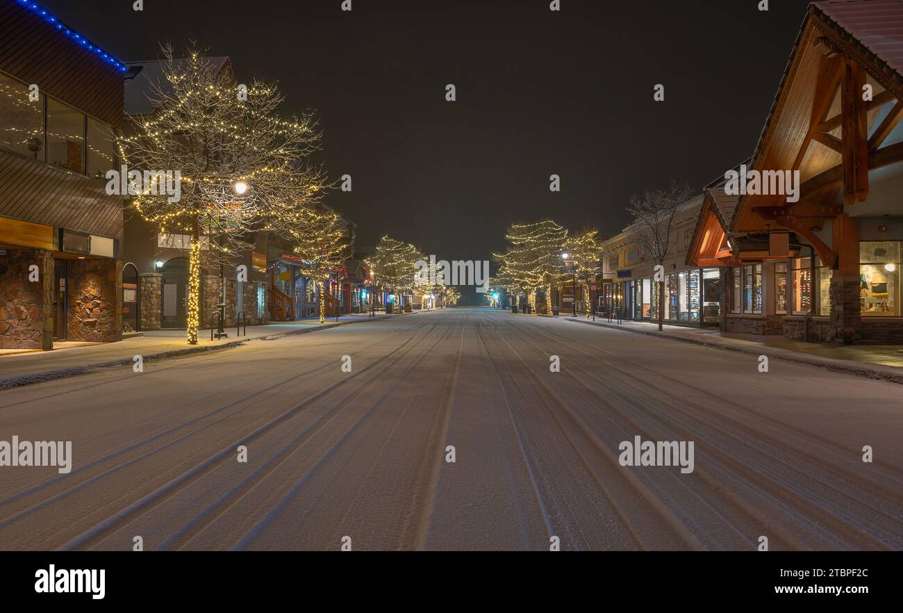 Night snowfall on Christmas decorated Main Street in Canmore, Alberta ...