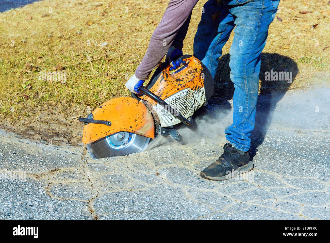 Cutting damaged asphalt cracks before installing new asphalt is an ...