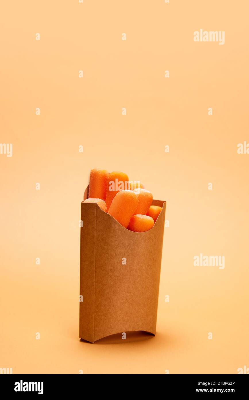 Cut, fresh, delicious carrots placed into carton packaging for fries ...