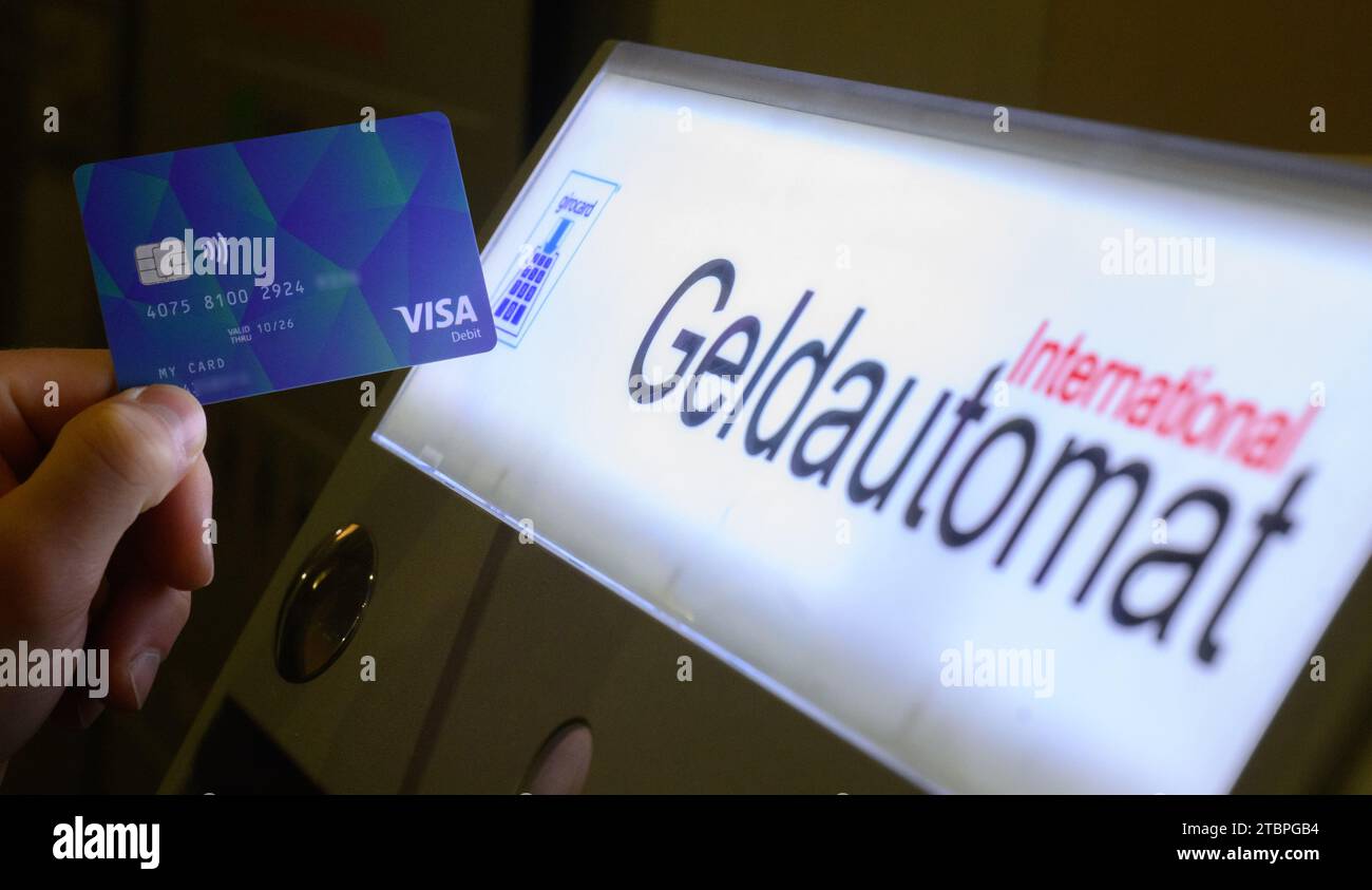 Hanover, Germany. 08th Dec, 2023. A VISA debit card is held in front of ...