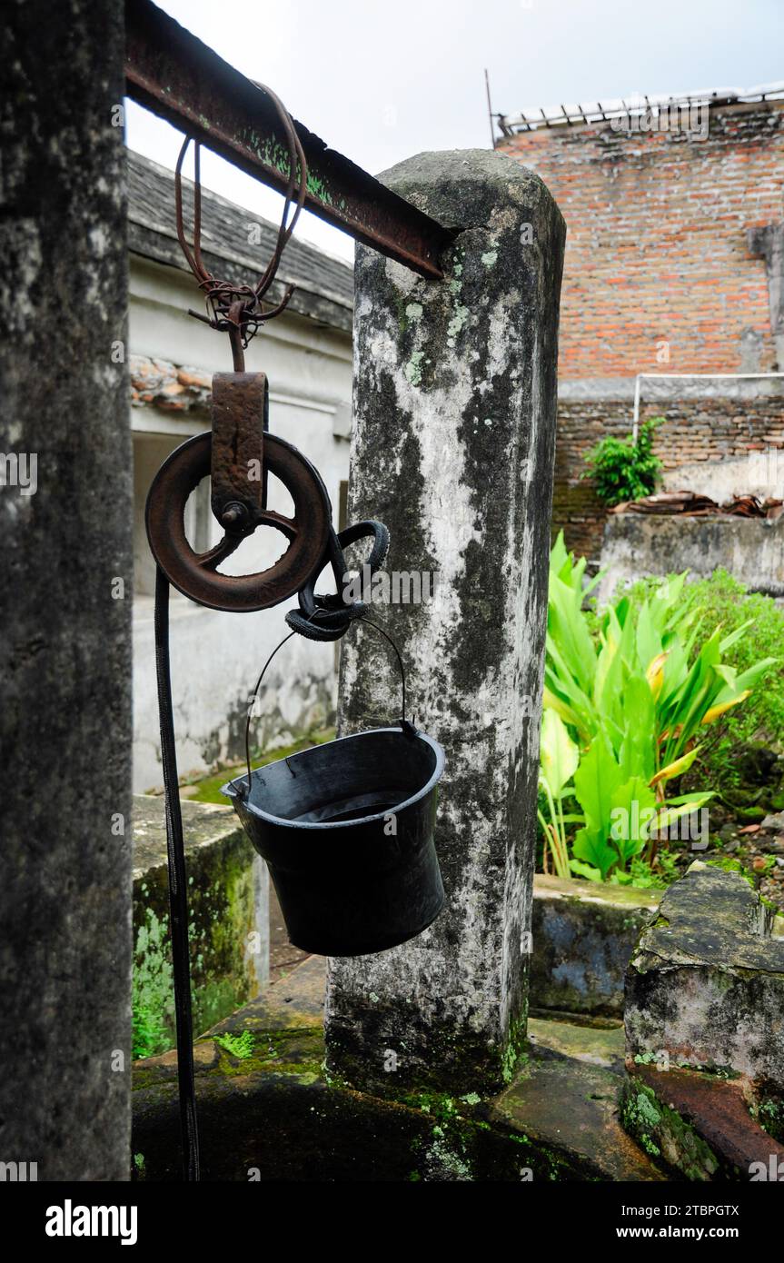 An ancient well with bucket in the water palace complex of Yogyakarta ...