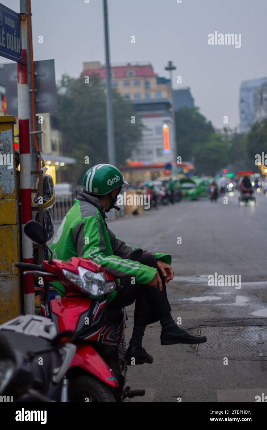 Grab guy resting on a motorcycle in Hanoi, Vietnam Stock Photo - Alamy