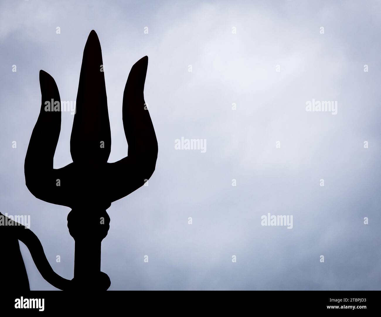 backlit isolated shot of hindu god shiva trident with dramatic ...