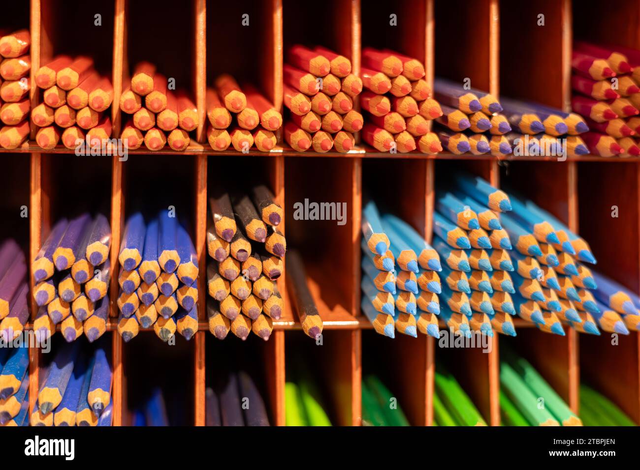 The colorful pencils arranged in a neat stack on a shelf Stock Photo ...
