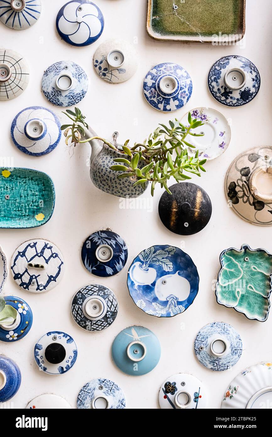 Ceramic pottery collection decorating wall. Vintage plates craft ...