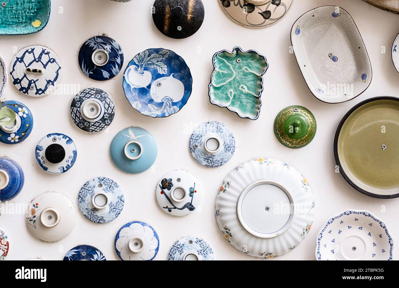 Ceramic pottery collection decorating wall. Vintage plates craft ...