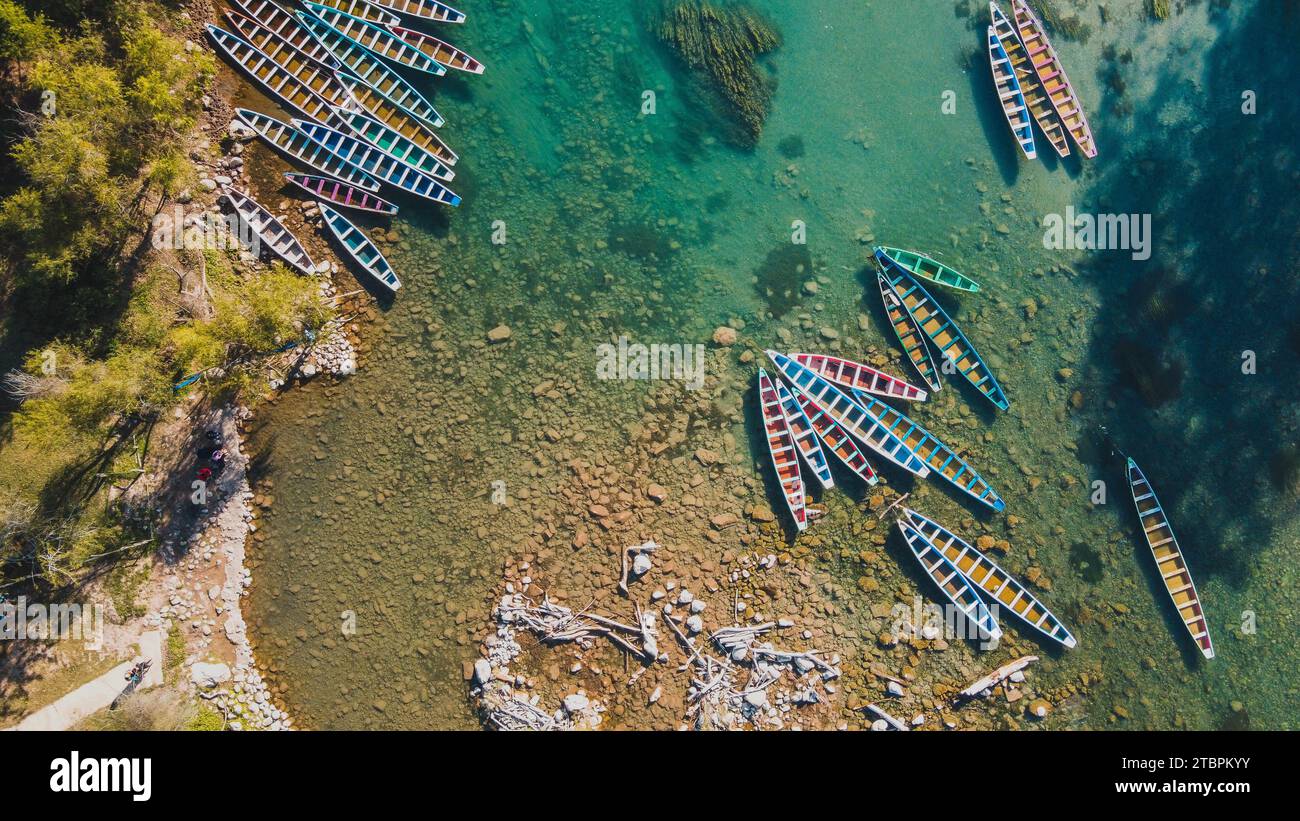 This aerial view showcases a picturesque scene of multiple small boats ...