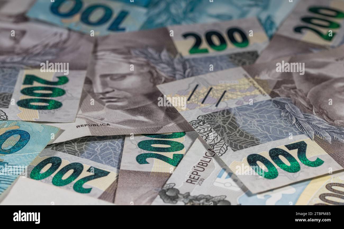 An array of Brazilian Reais banknotes lined up on a flat surface Stock ...