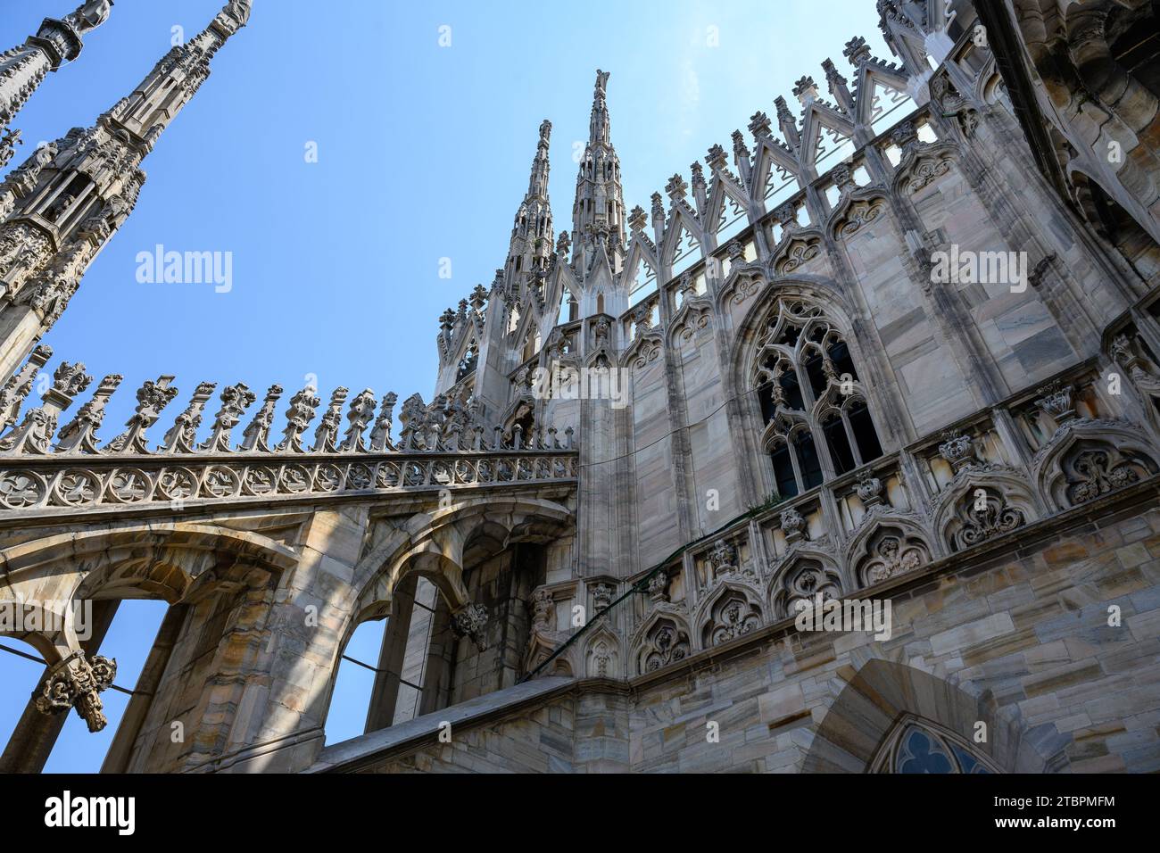Milan Cathedral view of the top side columns, artwork and window with ...