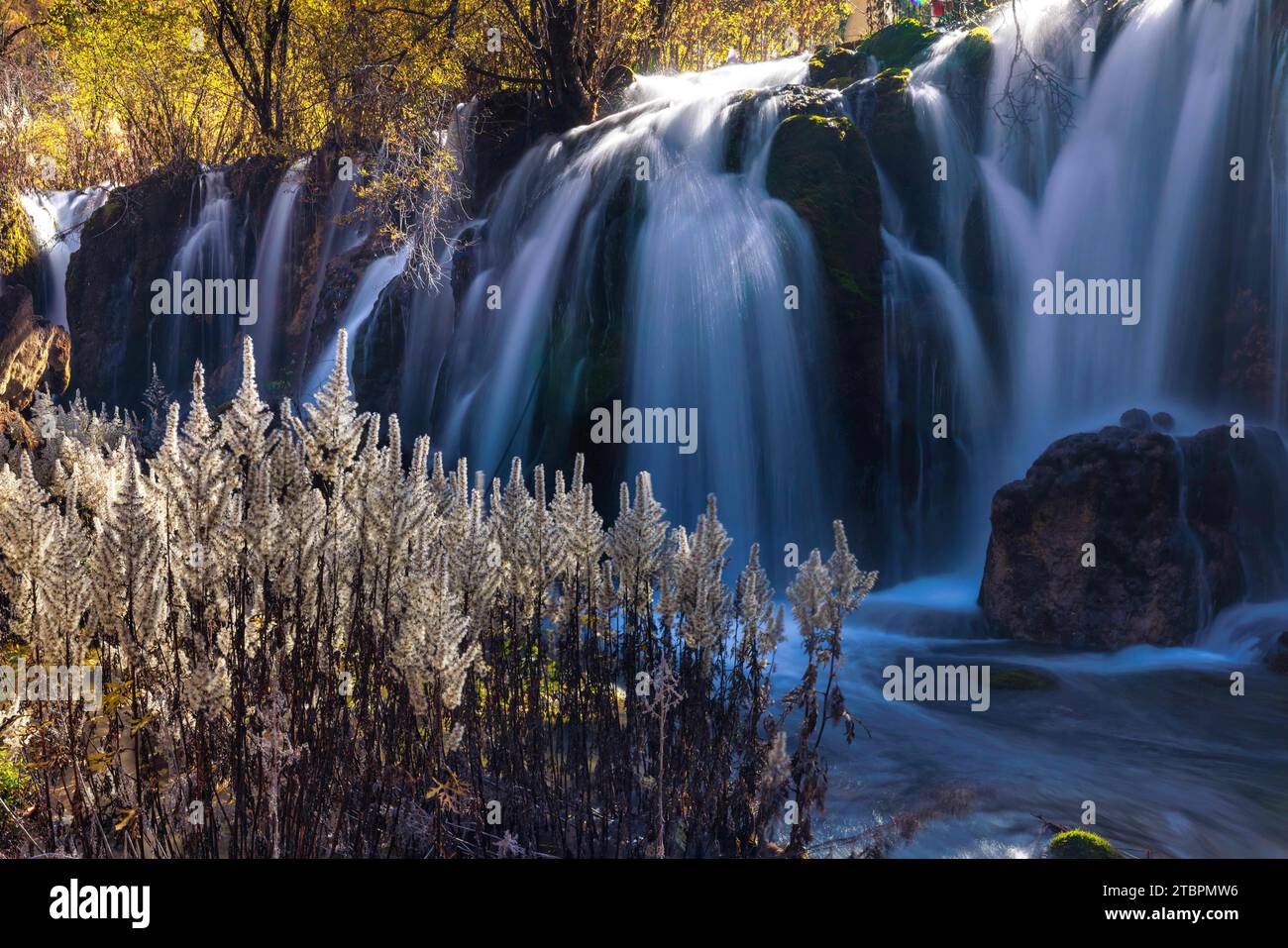 This image captures a stunning natural landscape featuring a cascading ...