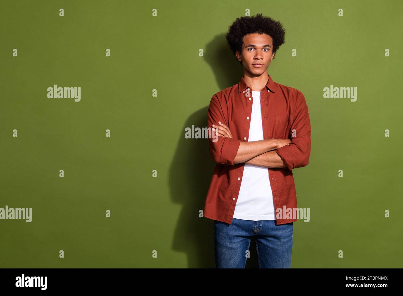 Photo portrait of nice young man crossed hands serious posing dressed ...