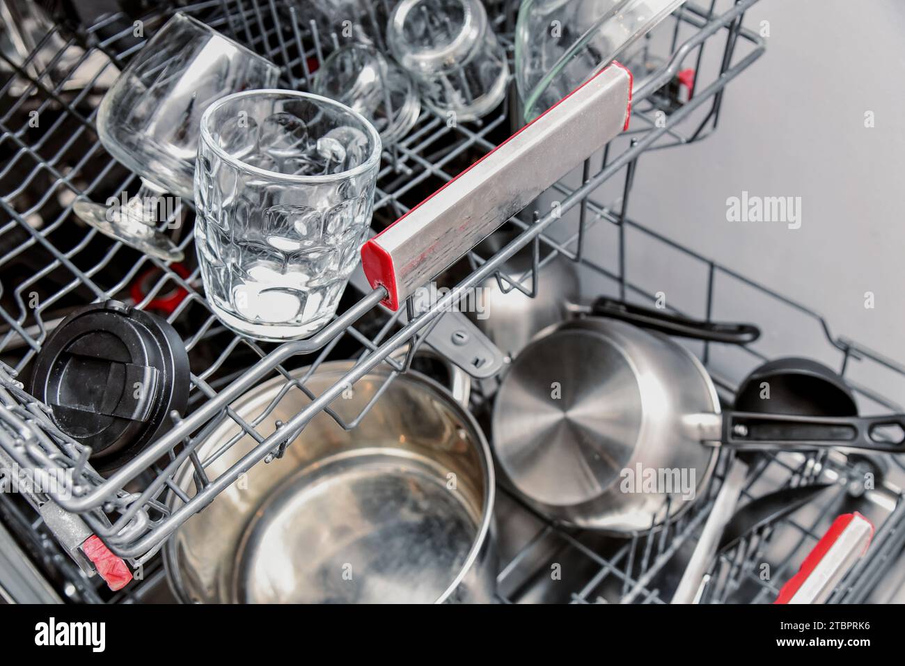 Various kitchen utensils loaded into the dishwasher inside. Washing ...