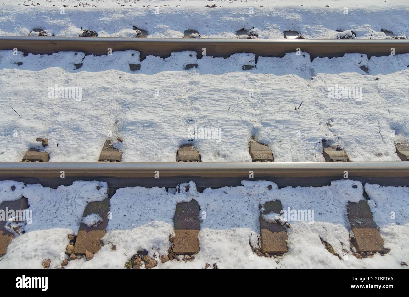 A detailed close-up of snow-covered railway tracks highlighting the ...