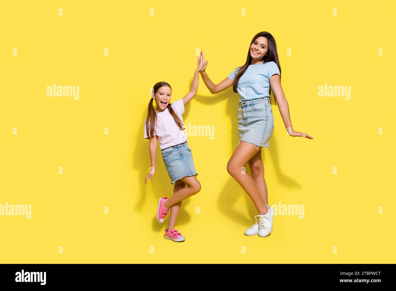 Photo of of two positive girls clap hands celebrate victory in school ...