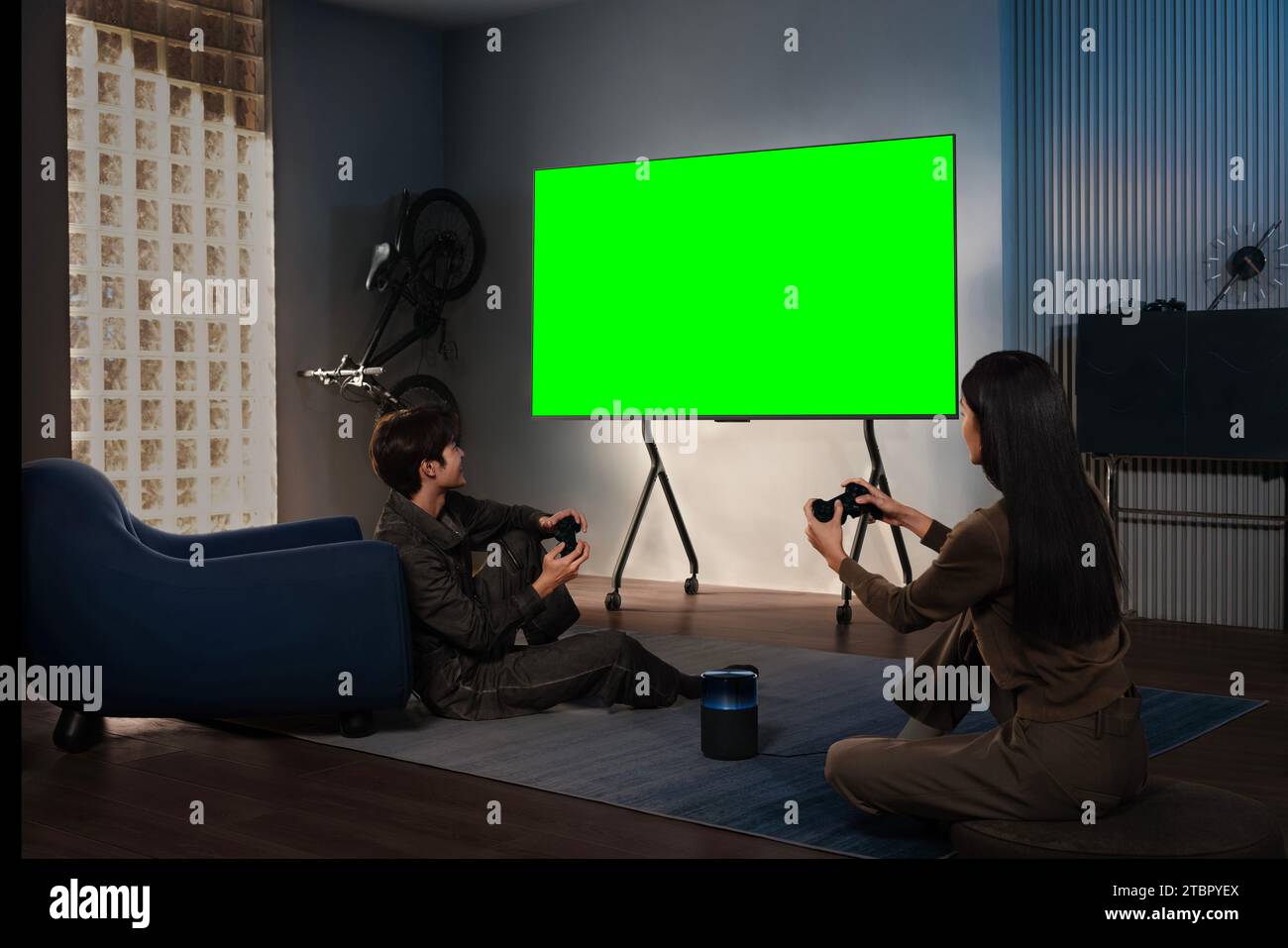 People are watching and enjoying next to the TV, monitor with green ...