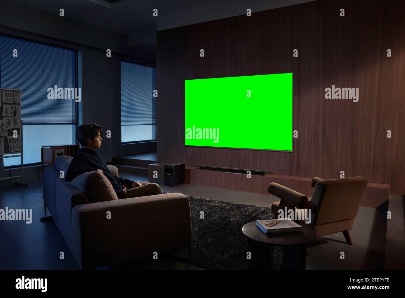 People are watching and enjoying next to the TV, monitor with green ...