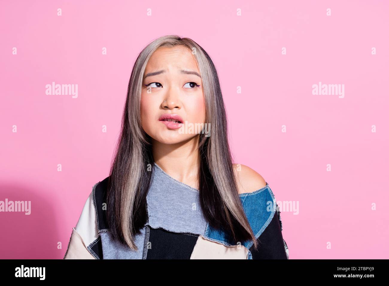 Photo of minded nervous filipino lady biting lips look empty space ...