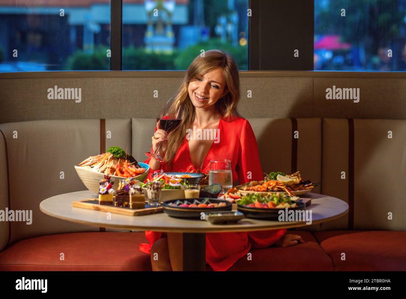 Elegant woman enjoying gourmet meal at upscale restaurant. Fine dining ...
