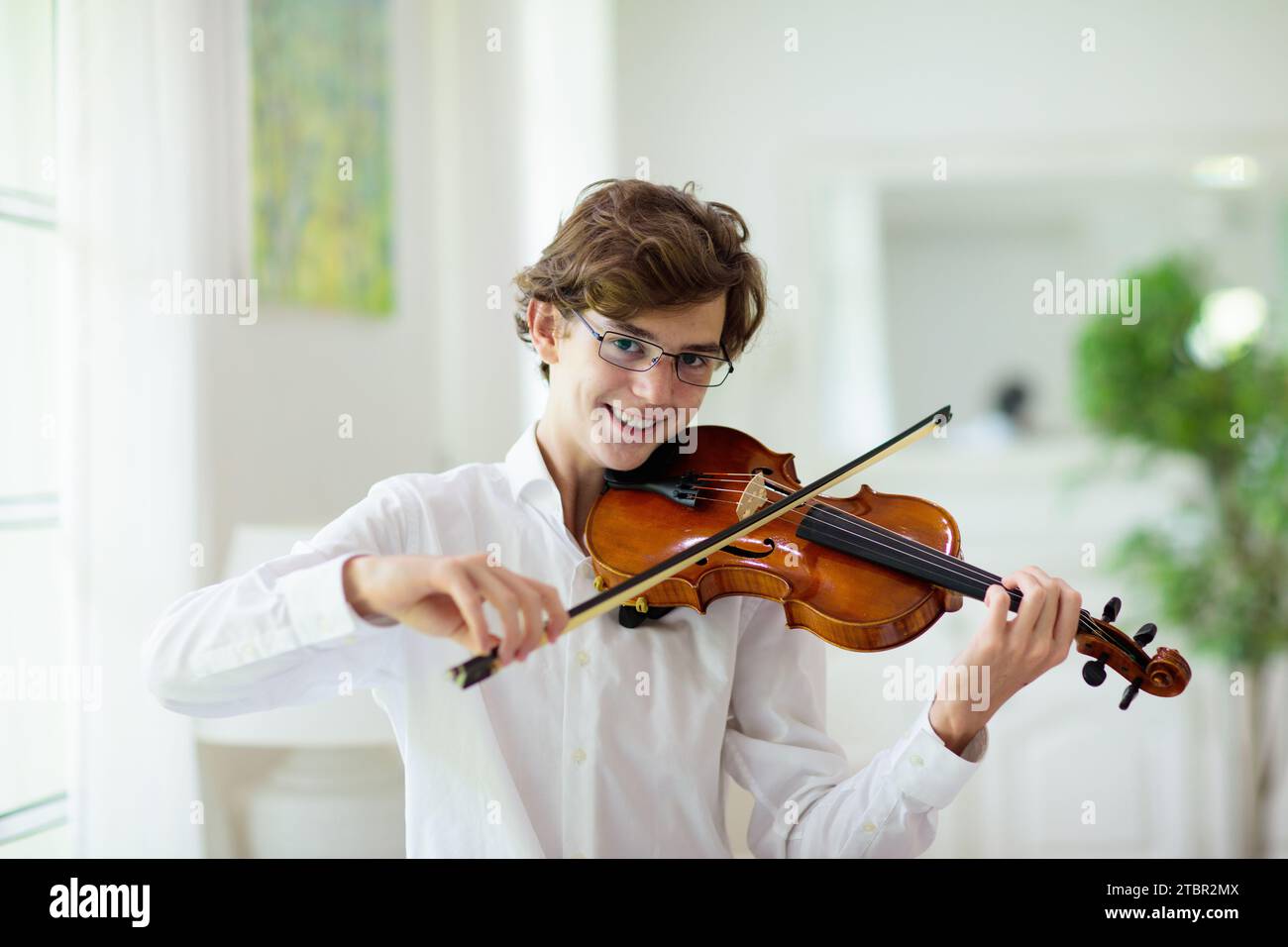 Man playing violin. Classical music instrument. Teenage boy practicing ...