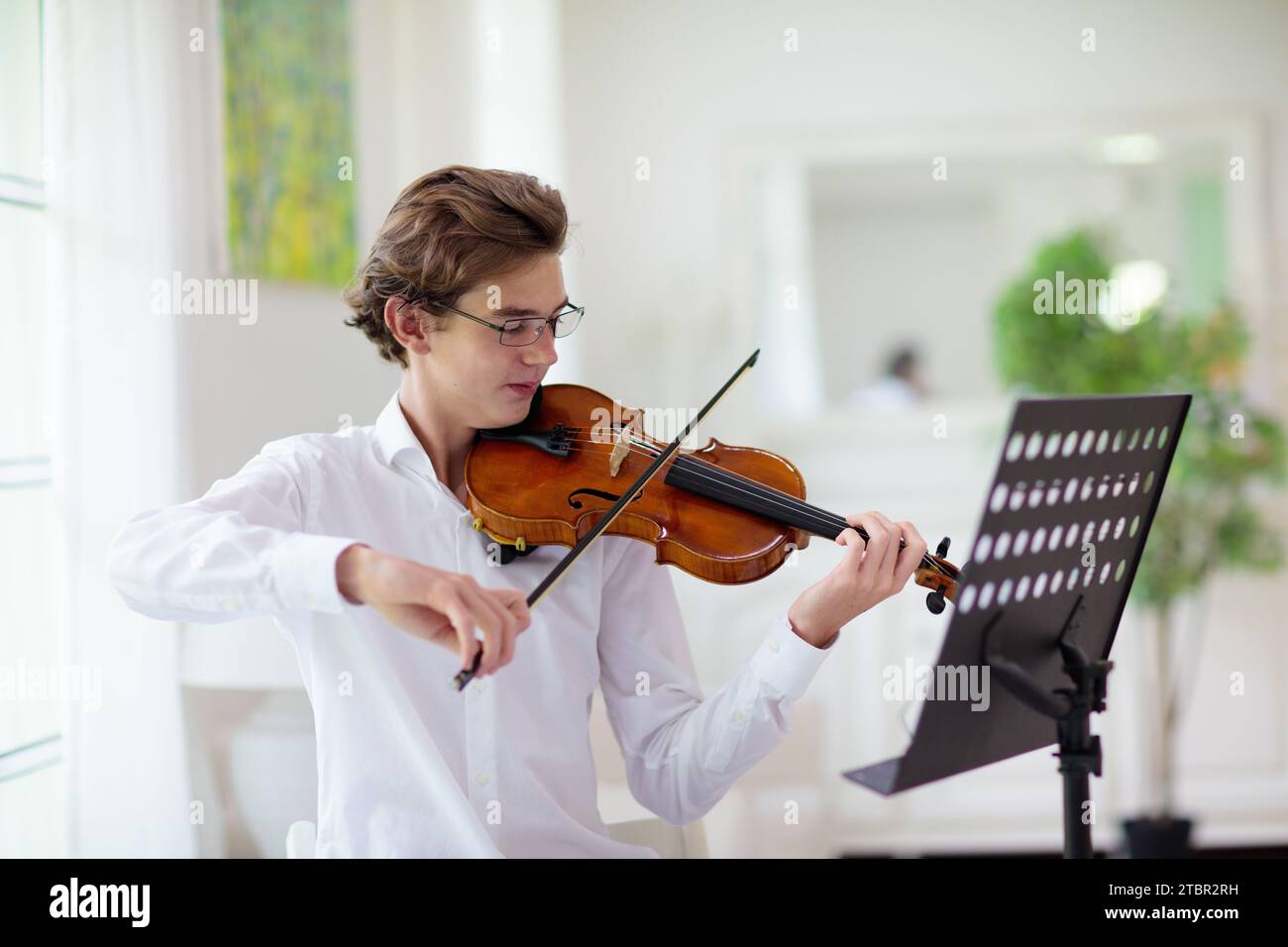 Man playing violin. Classical music instrument. Teenage boy practicing ...