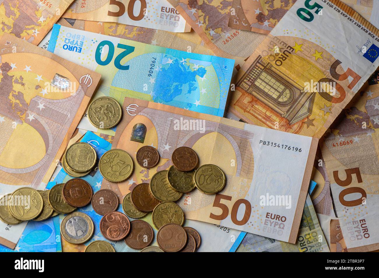 Euro bills and coins scattered on the table as a background Stock Photo - Alamy