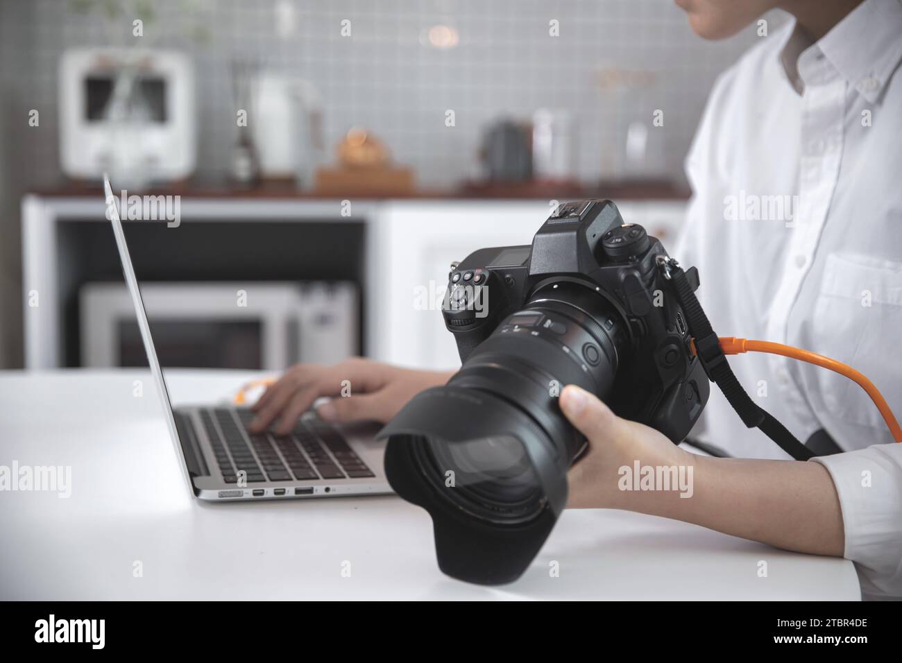 Female photographer, blogger reviewing photos taken with her camera ...