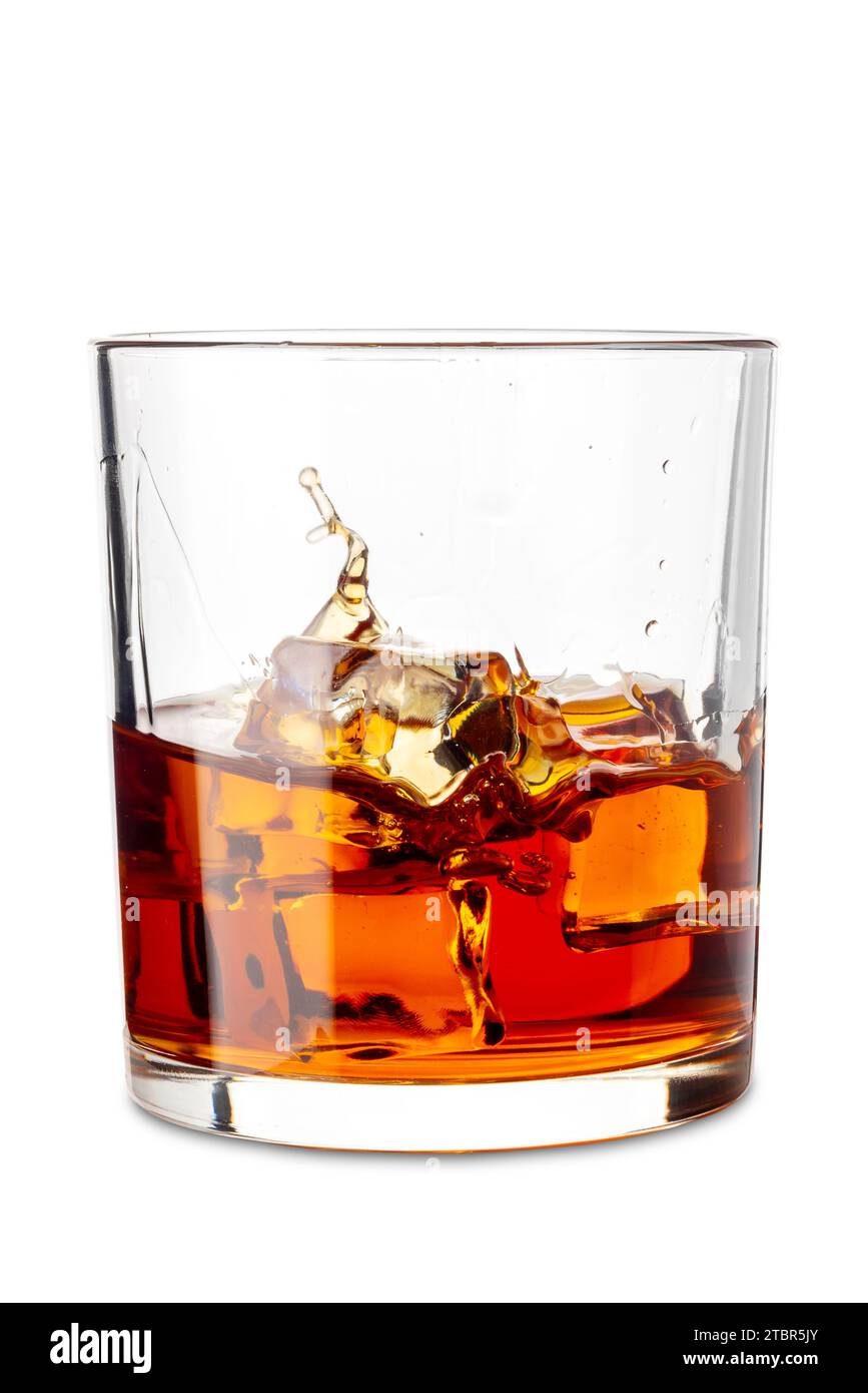Glass of whiskey or bourbon with splashing of ice cubes falling , Whiskey on the rocks, isolated ...