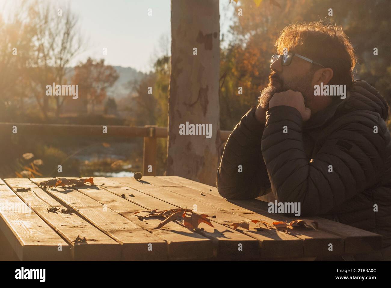 Worried man sitting alone outdoors hi-res stock photography and images ...