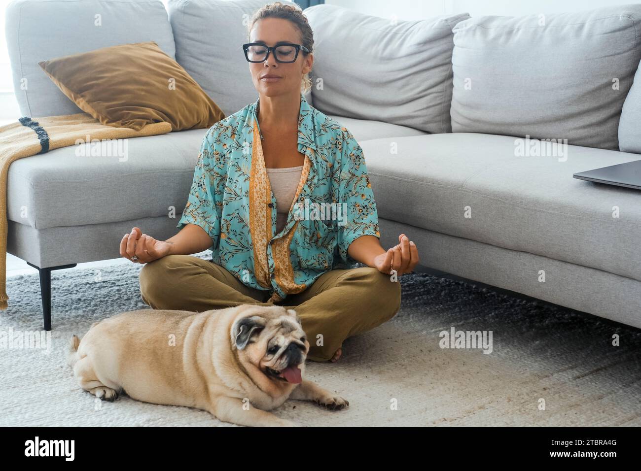One woman having relax at home with yoga routine lotus position in ...