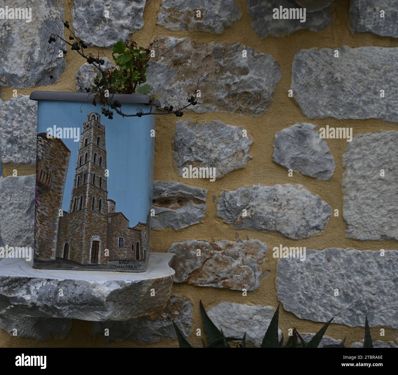 Hand painted tin can with basil plants on the exterior of a local ...