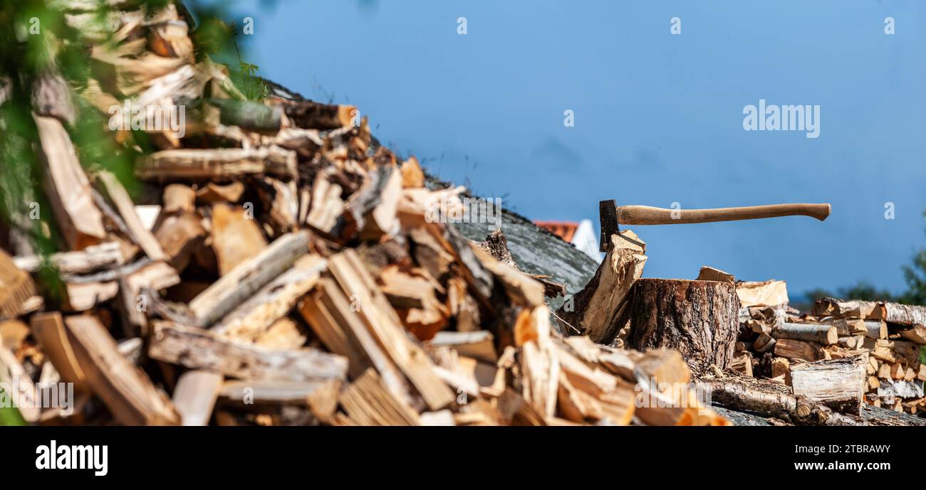 Chopped firewood with chopping block and axe Stock Photo - Alamy