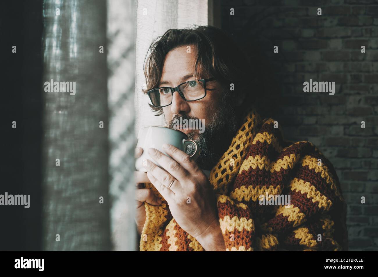 Side portrait of unhealthy man unhappy at home drinking medicine or ...