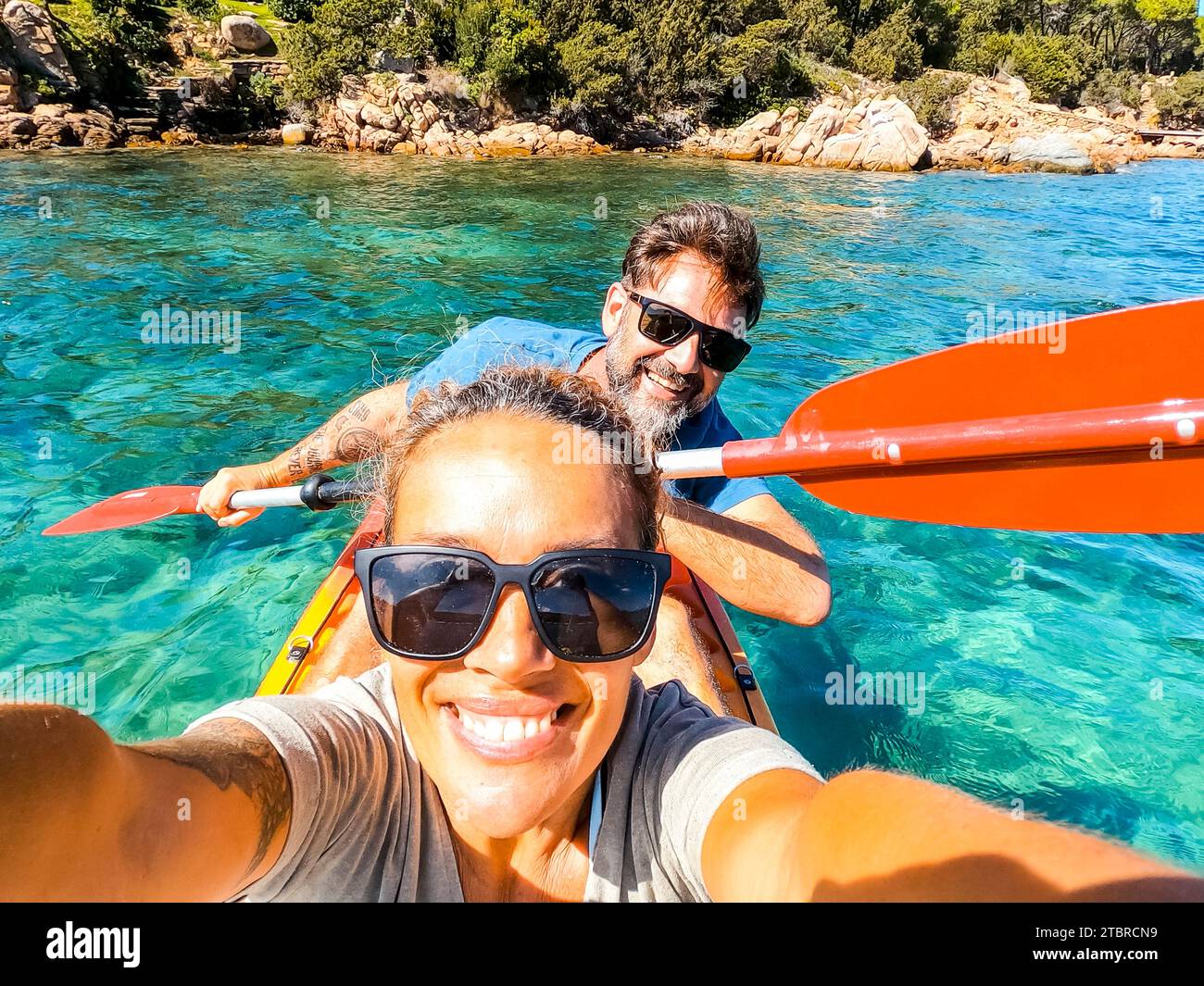 Happy active adult couple enjoying kayak canoe excursion trip tour on ...