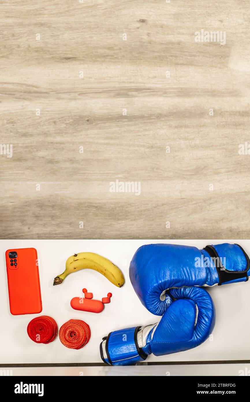 Vertical photo boxing equipment, banana, headphones and cell phone on a ...