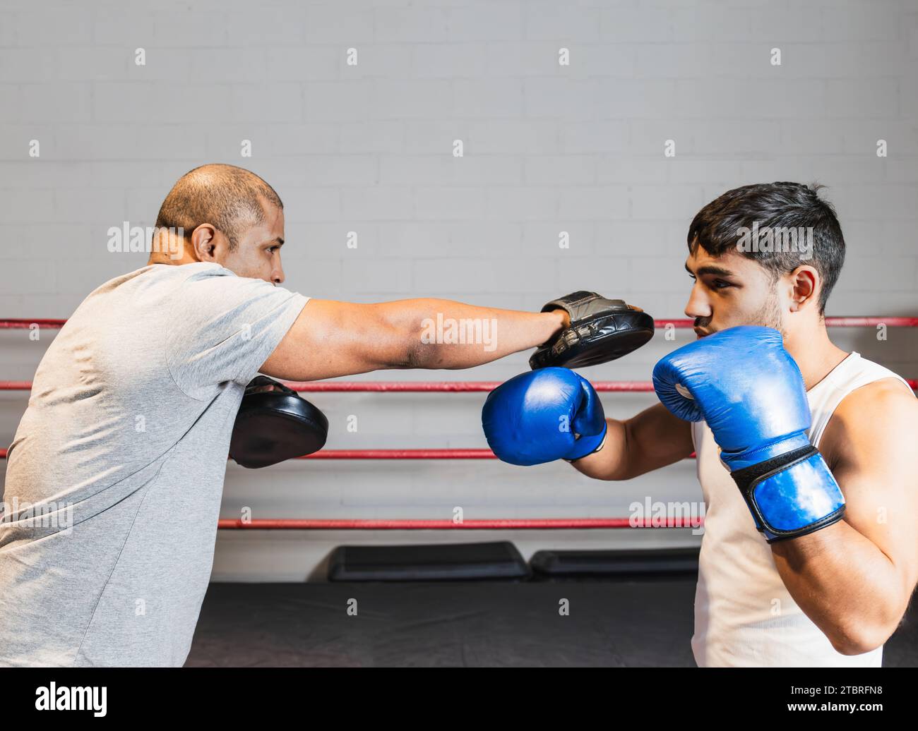 Horizontal photo boxing class from a black teacher to a young adult ...