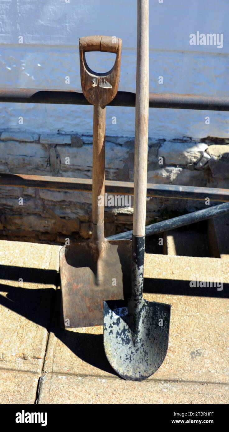Older shovel has wooden hangle and the newer shovel has long straight ...