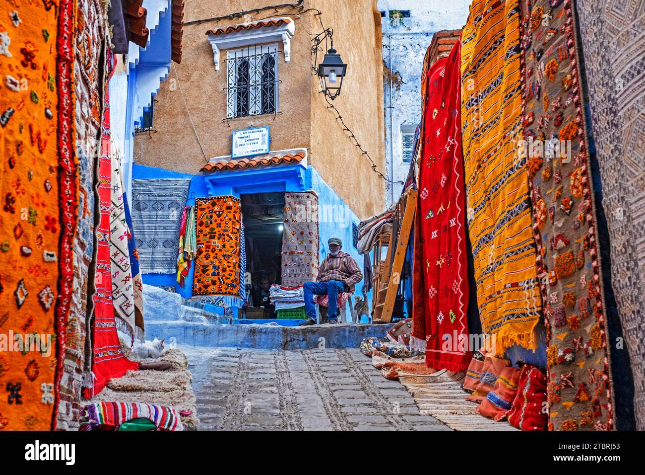 Shops selling colourful Berber rugs / Moroccan carpets in alley of ...