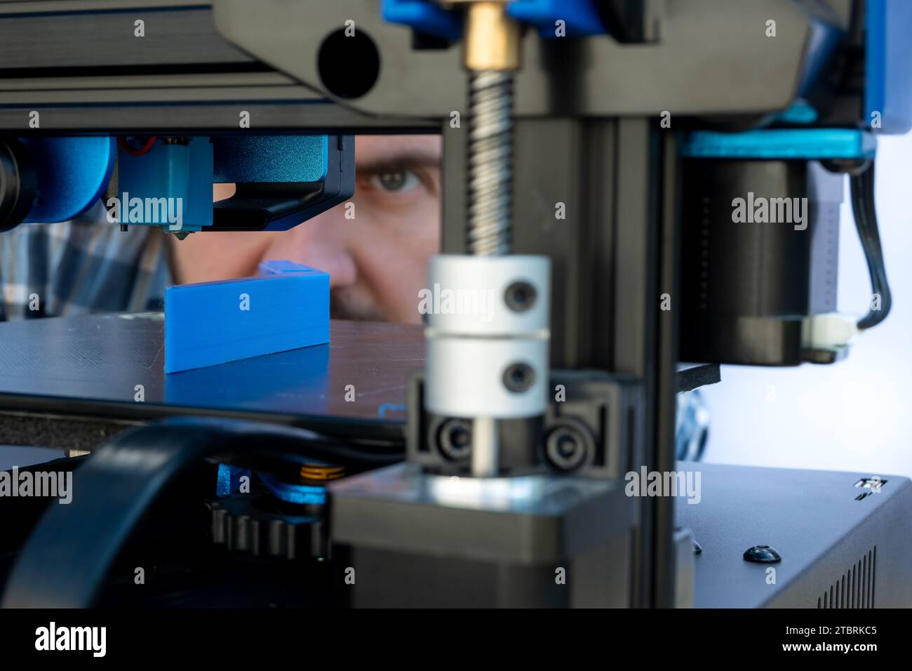 Man watching a 3D printer Stock Photo - Alamy