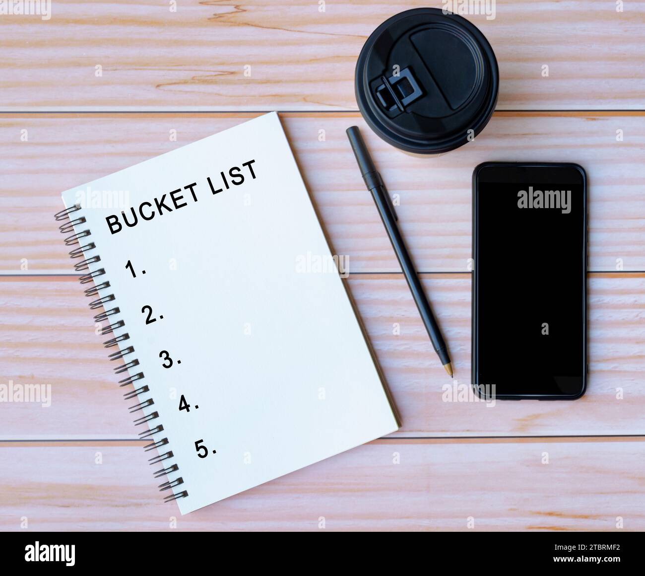 Bucket List word written on notepad with coffee, pen and smartphone ...